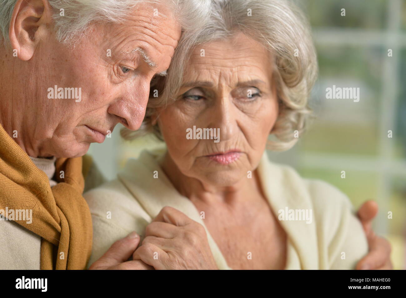 Portrait of sad senior couple Stock Photo - Alamy