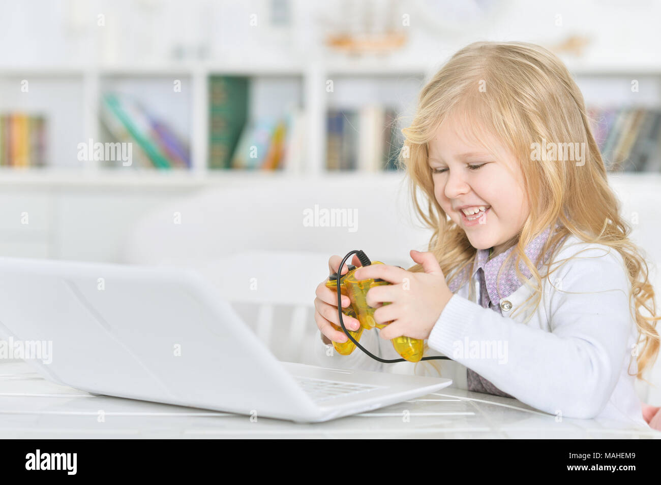 adorable little girl using laptop Stock Photo - Alamy