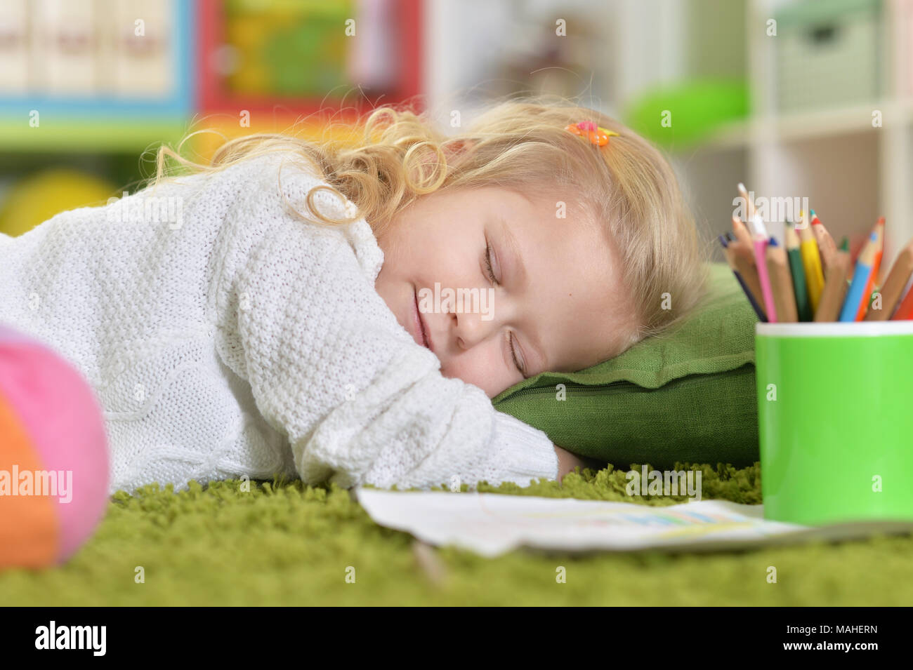 Cute little girl falling asleep Stock Photo - Alamy