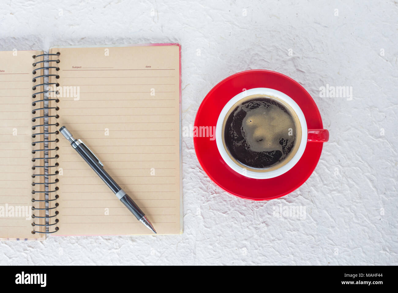 a cup of coffee with notebook and pencil on white background Stock ...
