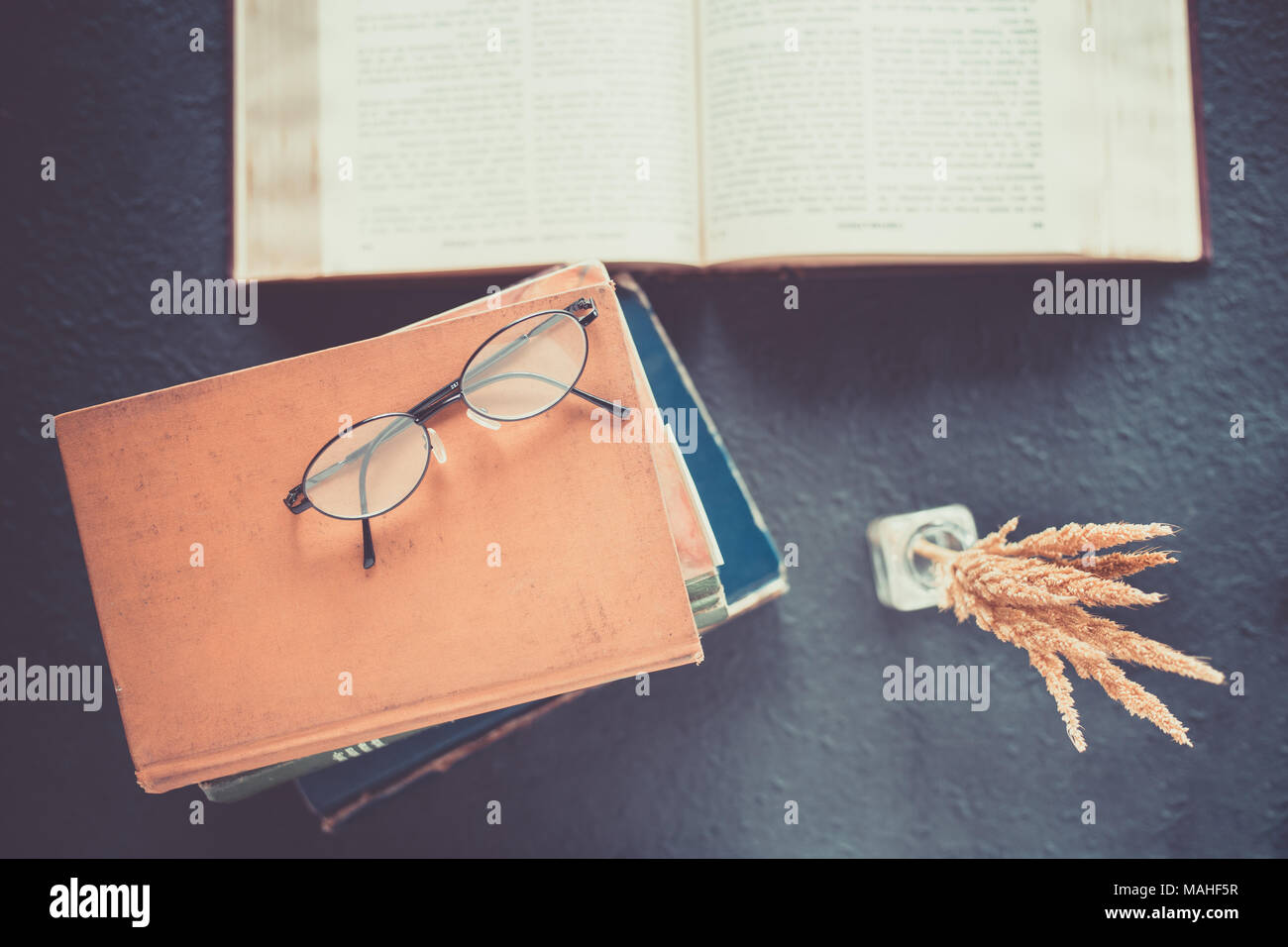 Top view of stack book with eye glasses on black color ground Stock ...