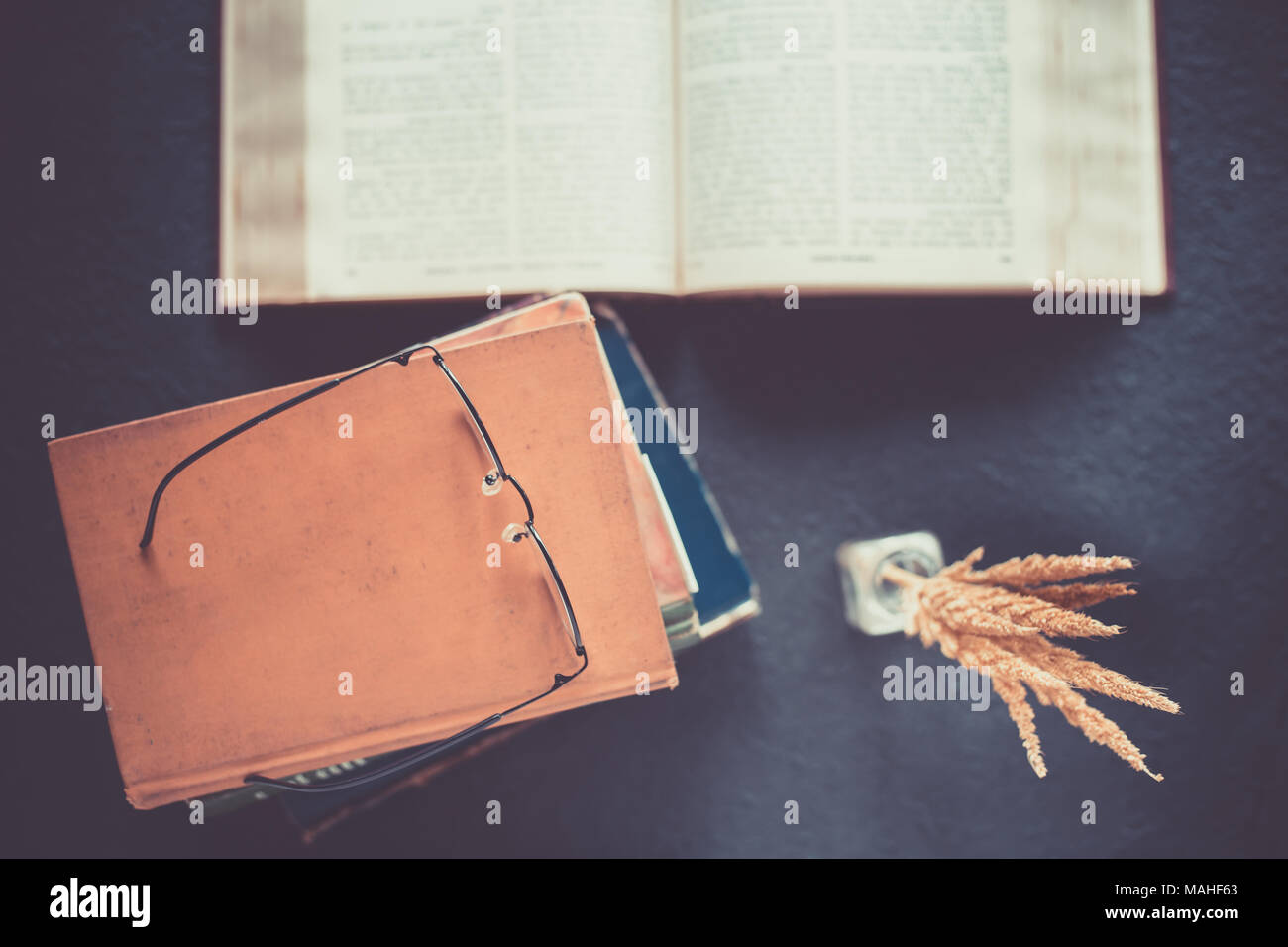 Top view of stack book with eye glasses on black color ground Stock ...