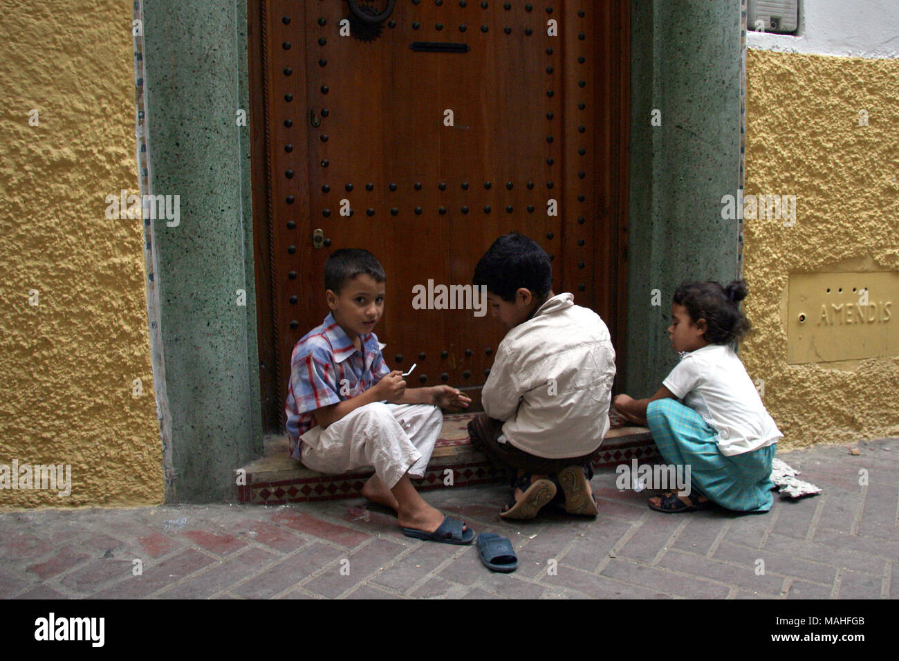 Kids playing football on streets hi-res stock photography and images ...