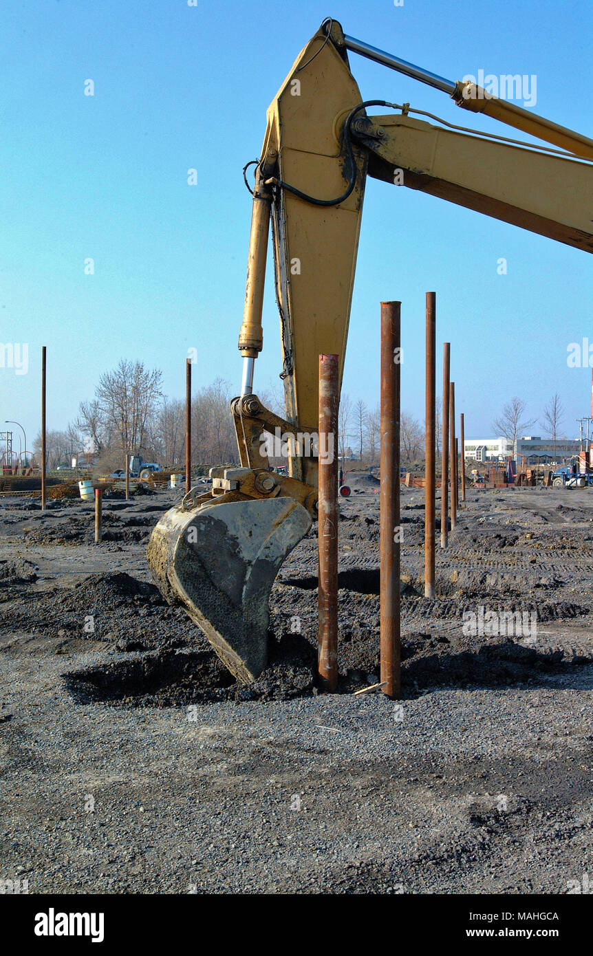 Mechanical shovel in close up unloading earth at moving works in ...