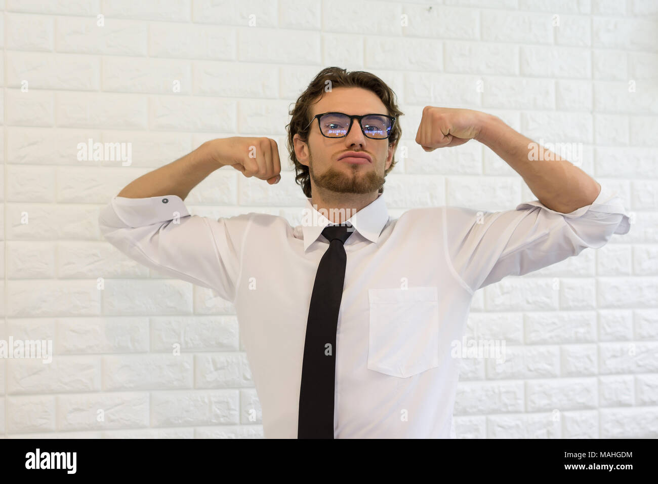 Portrait of strong business man flexing muscle Stock Photo - Alamy