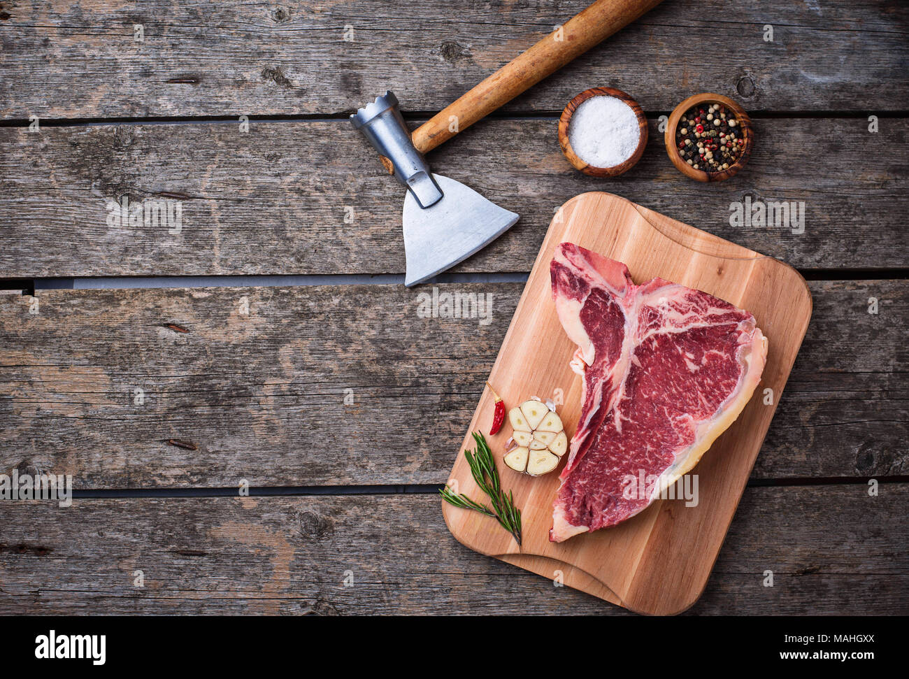 Raw T-bone steak with hatchet. Top view Stock Photo - Alamy