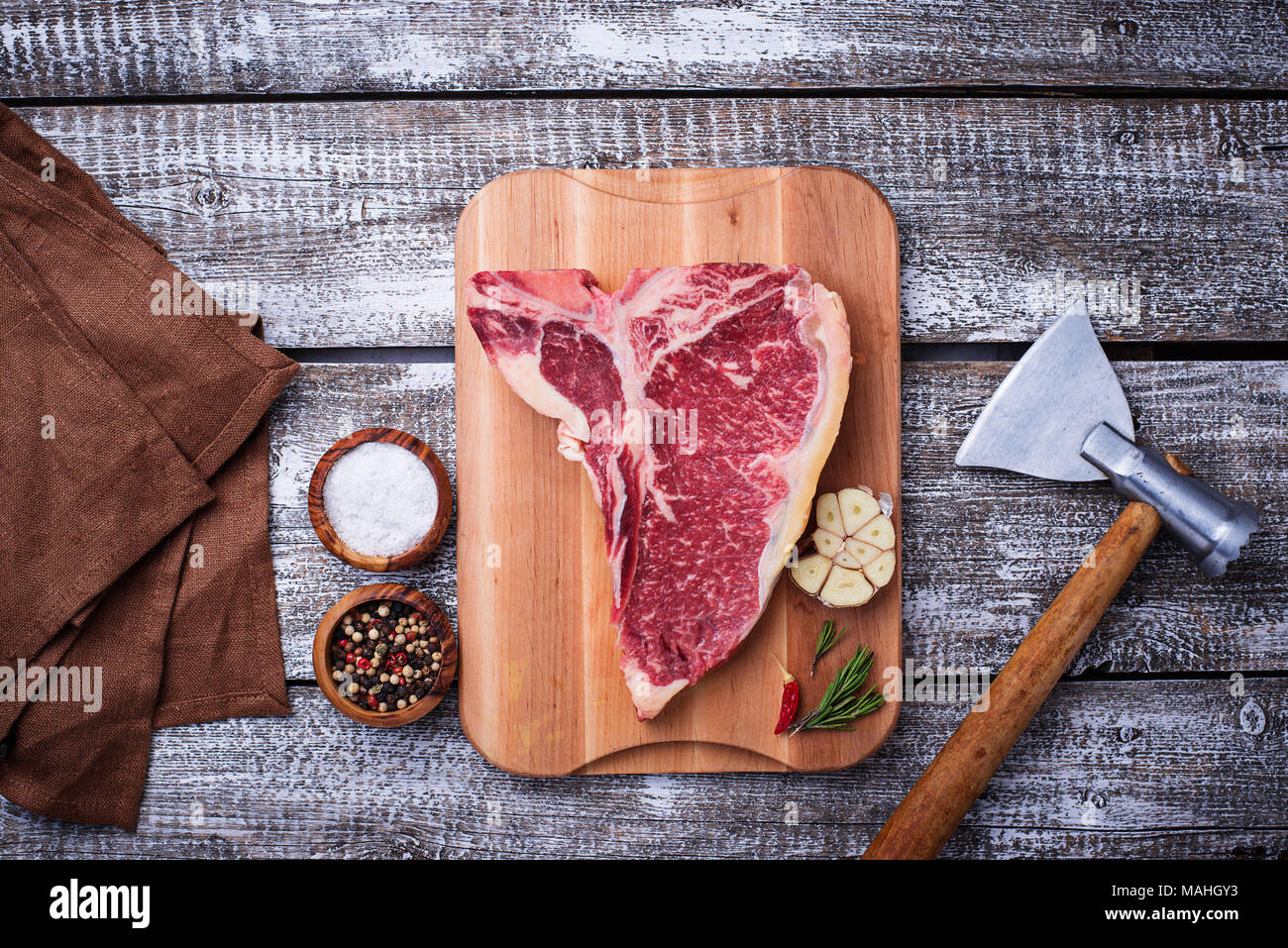 Raw T-bone steak with hatchet. Top view Stock Photo - Alamy