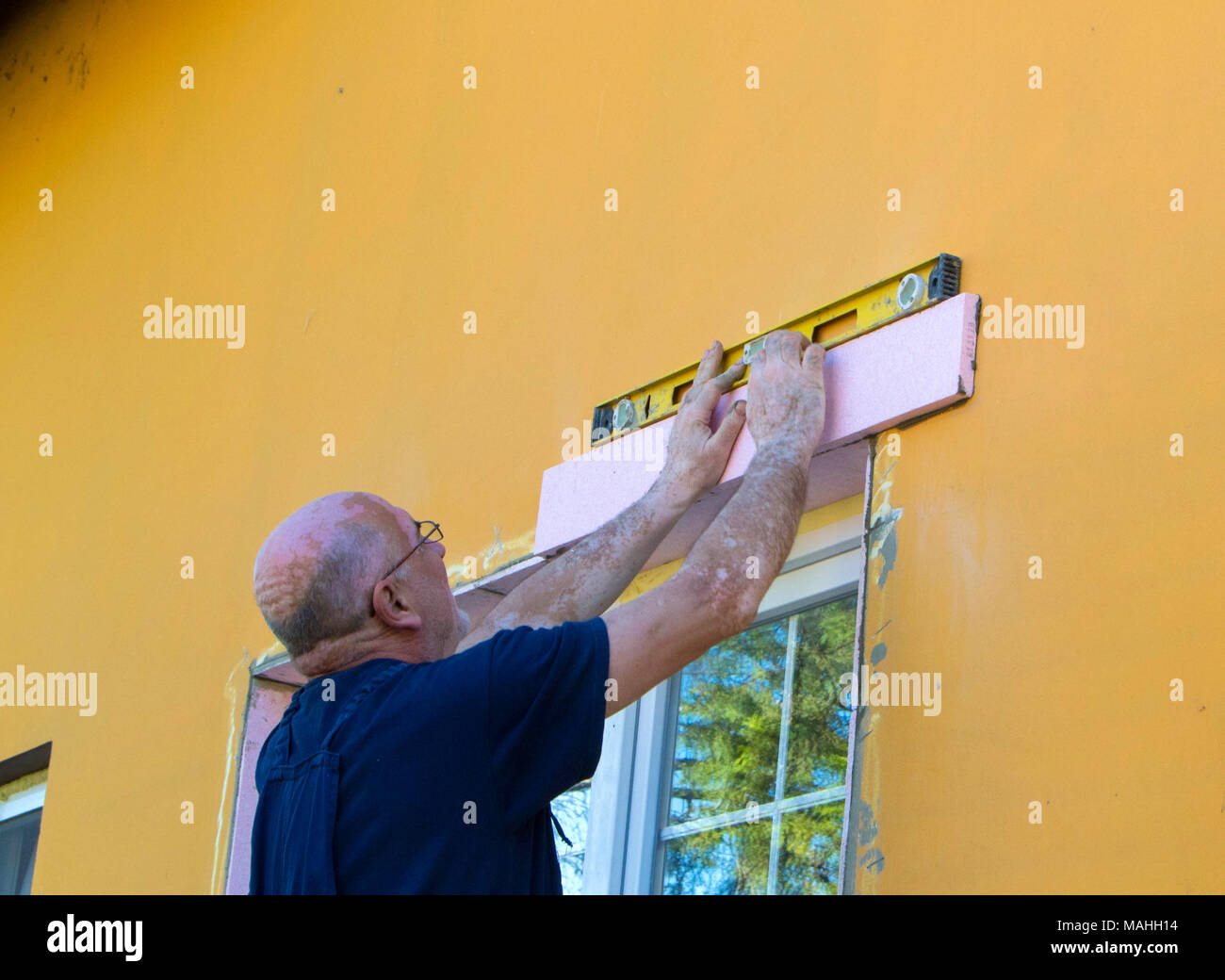 The worker measures the window. Installing a new window and finishing ...