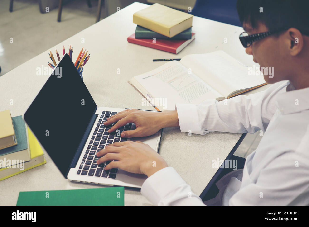 Student making research on laptop and browse internet. Education ...