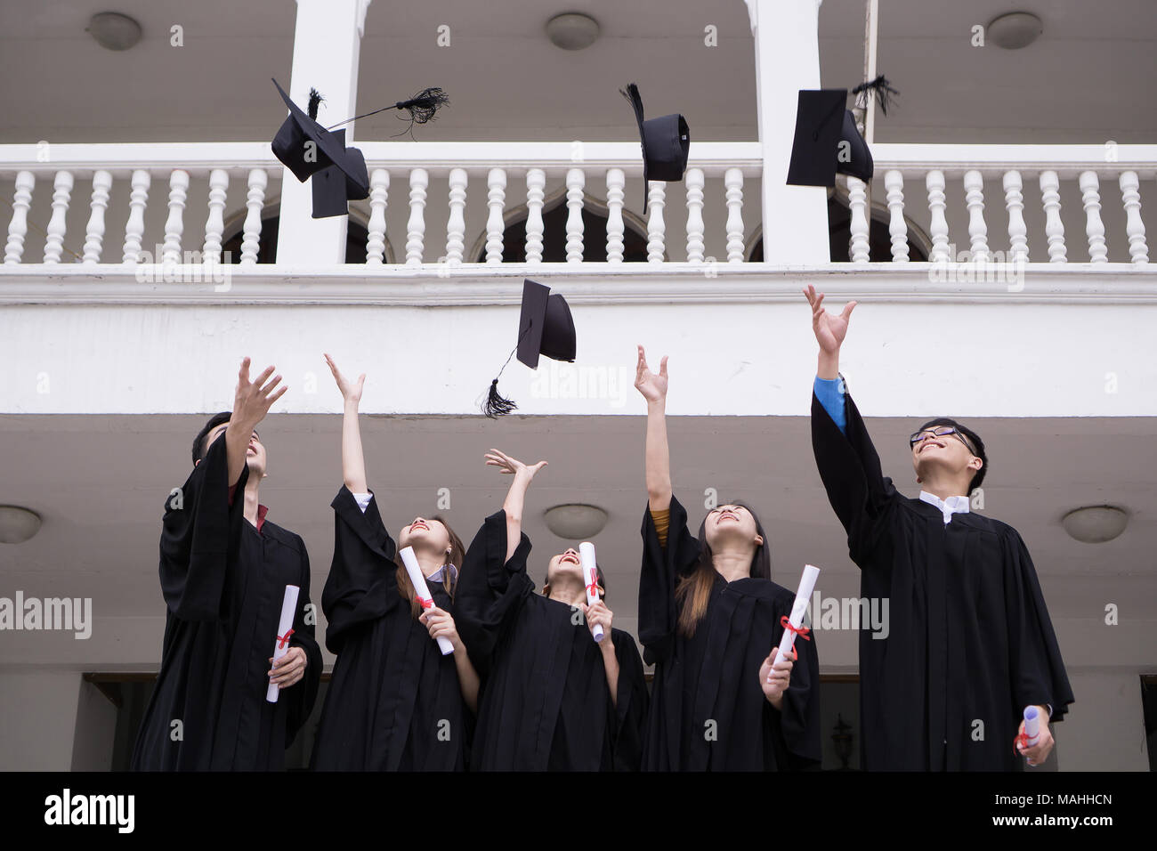 Group of Successful students with congratulations together throwing ...