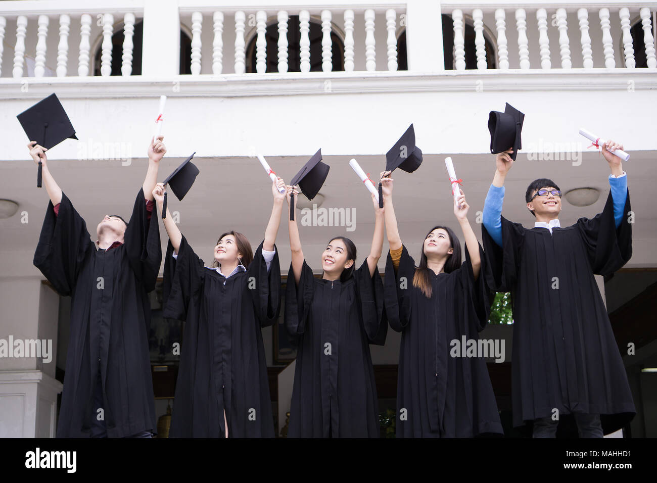 Group of Successful students with congratulations together throwing ...