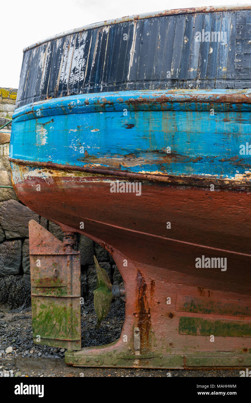 the hull and keel of an old fishing trawler in the harbour at newlyn in ...