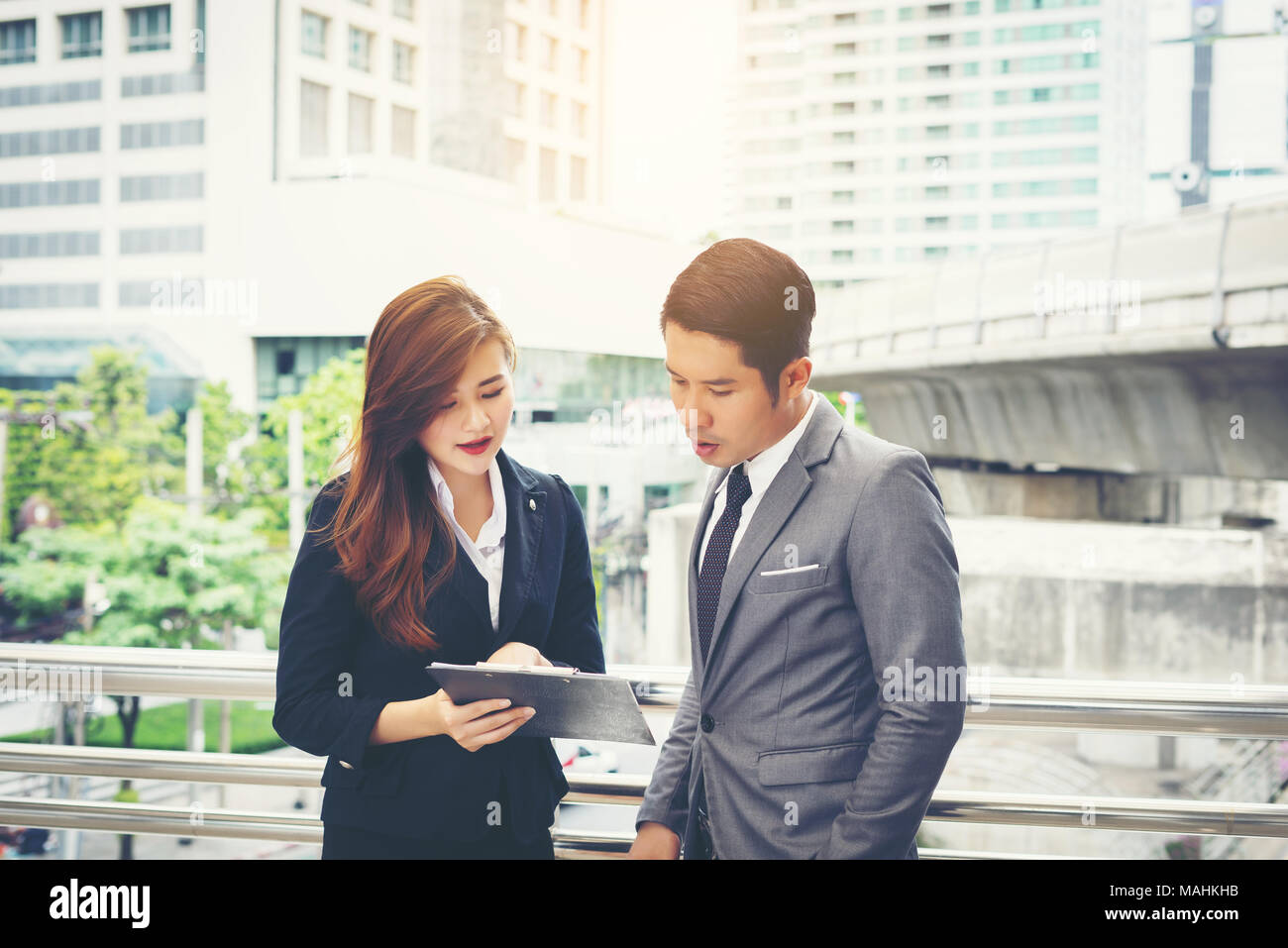Business man pointing at document with smile and discussing something ...
