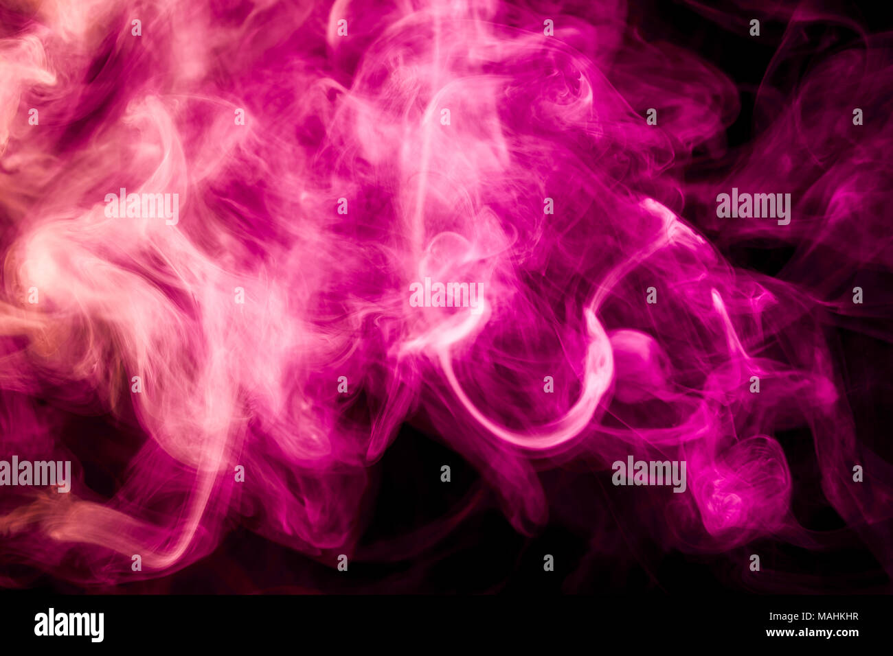 Colorful red smoke on a black isolated background. Background from the ...