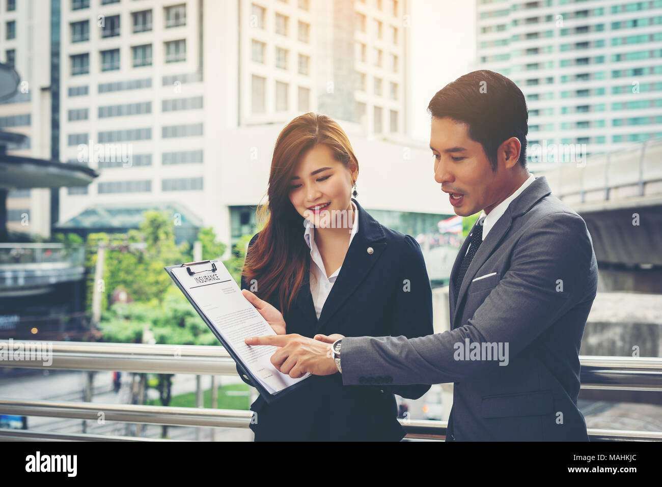 Business man pointing at document with smile and discussing something ...