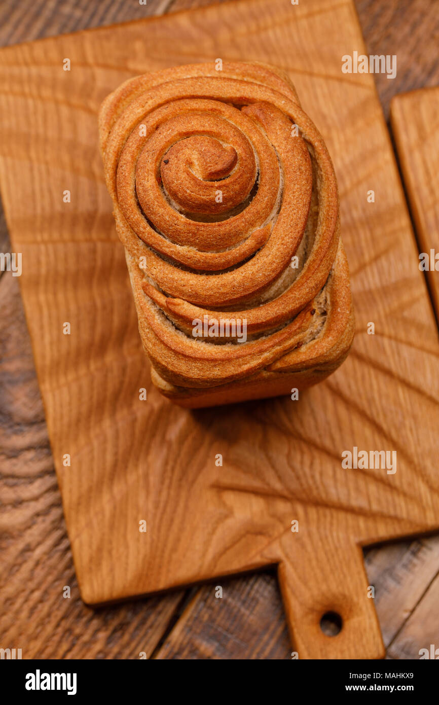 Beautiful homemade bread on a textured wooden board. A beautiful ...