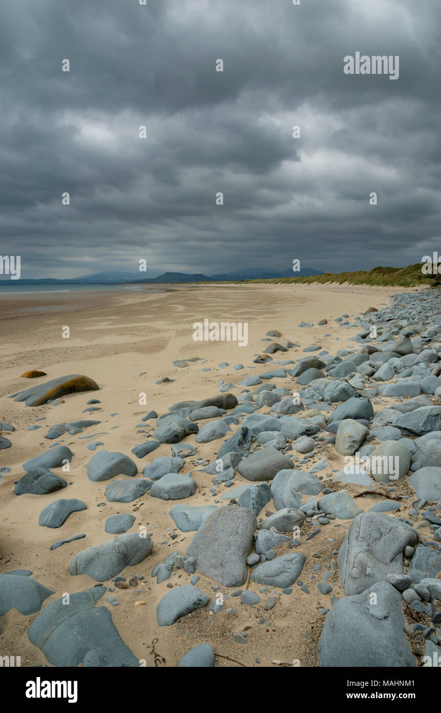 View along the length of Harlech beach on an overcast day. Snowdonia ...