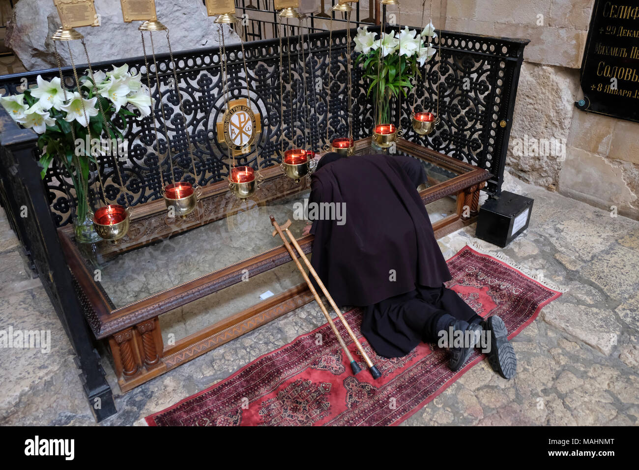 A Russian Orthodox worshiper praying over remains of the “Judgement ...