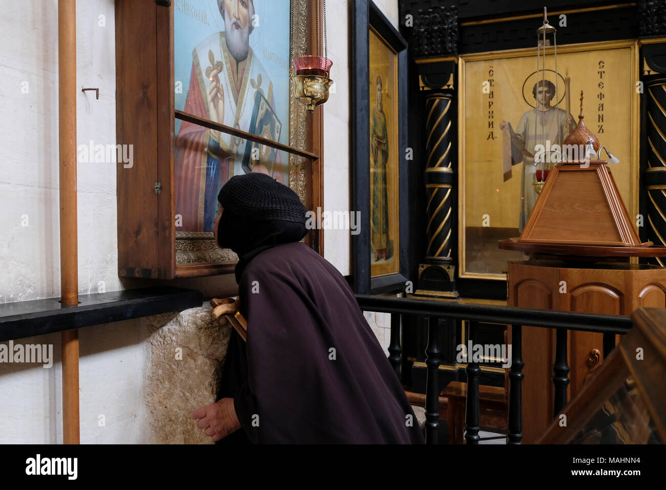 Russian Orthodox worshiper kissing a religious icon inside the Church ...