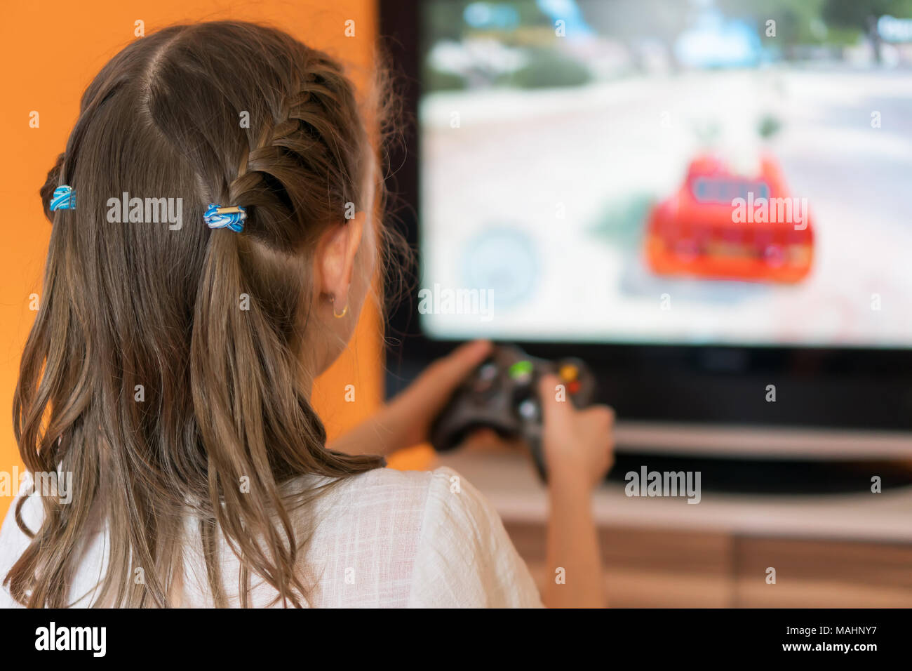 Little girl playing computer game with a joystick Stock Photo - Alamy