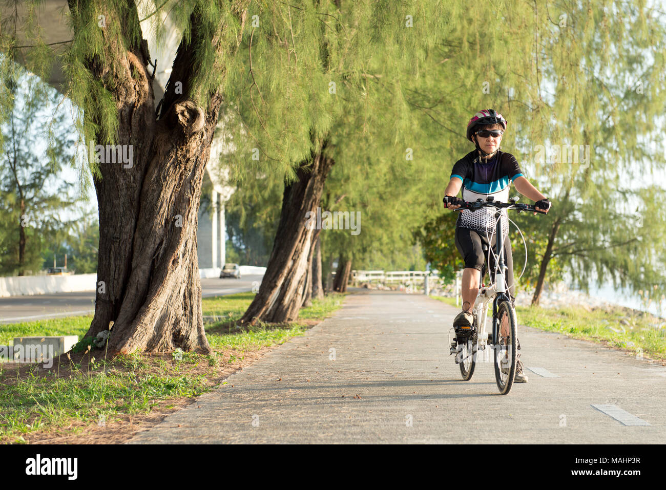 Woman riding bike helmet hi-res stock photography and images - Alamy
