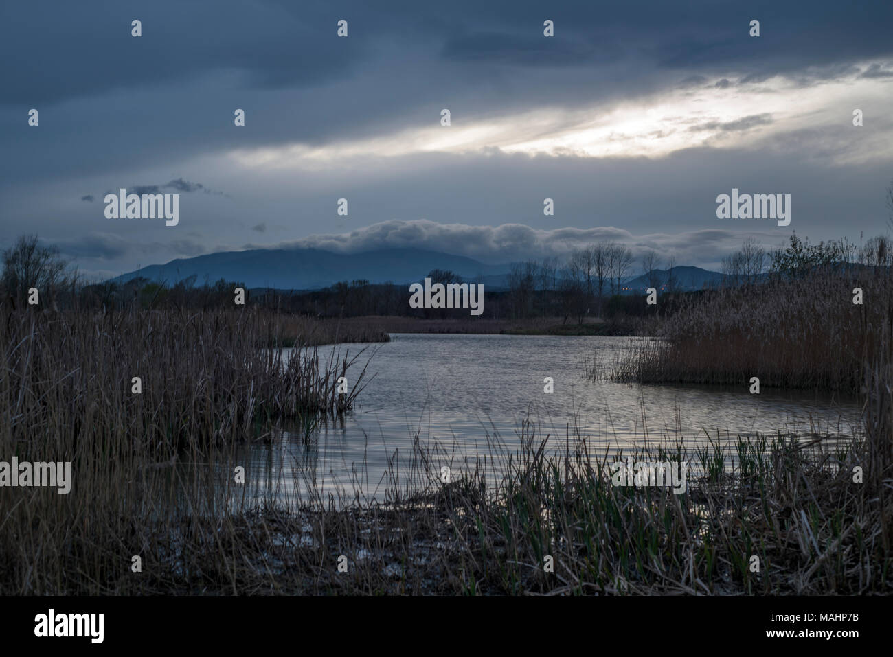Cloudy day, sunset, mountains and pound. Sils (Catalonia) Spain Stock ...