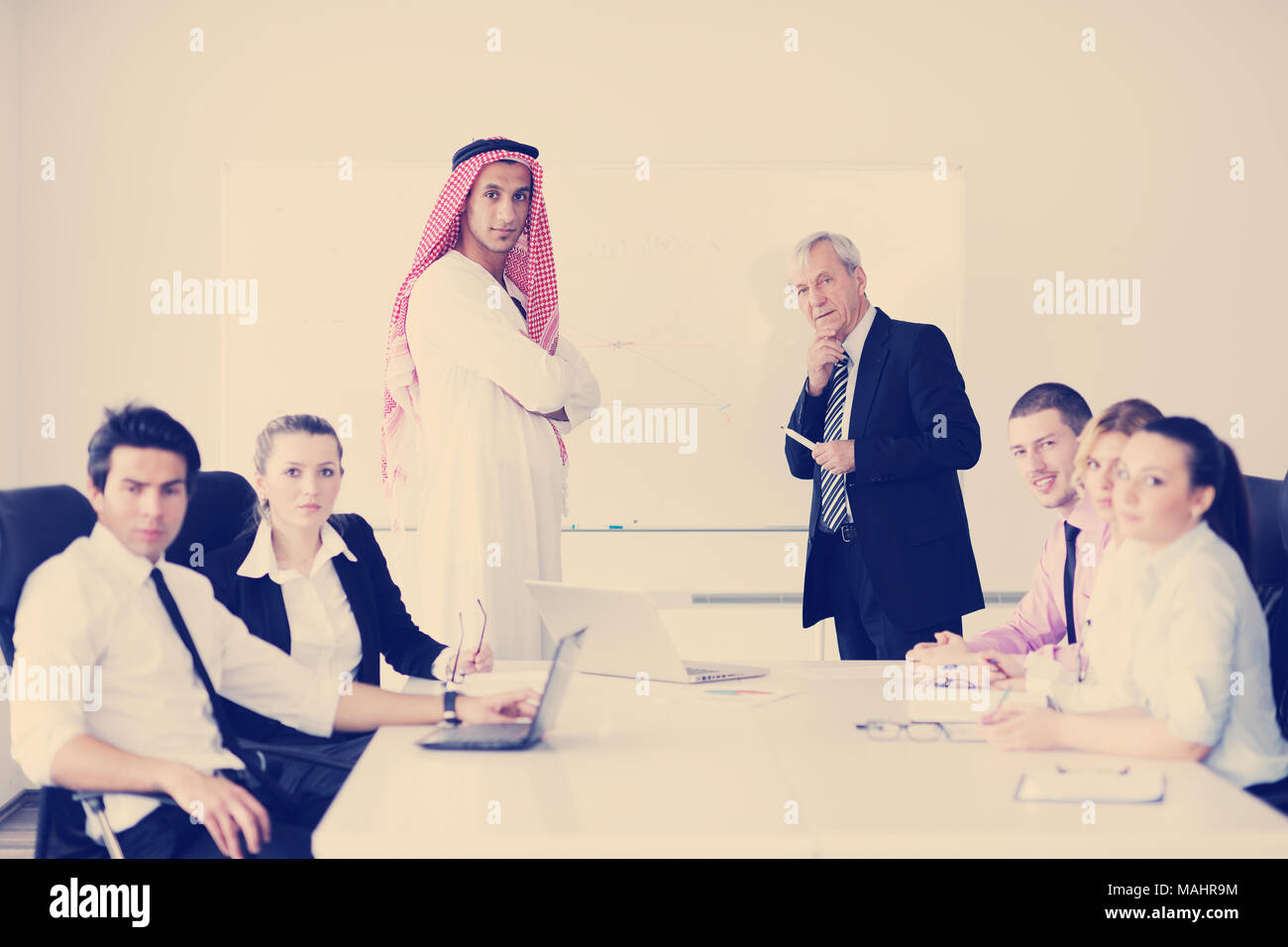 Business meeting - Handsome young Arabic man presenting his ideas to ...