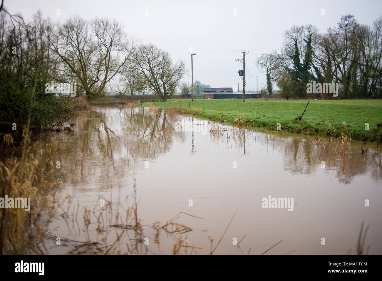 High water levels from a river causing flooding, brought on by climate ...