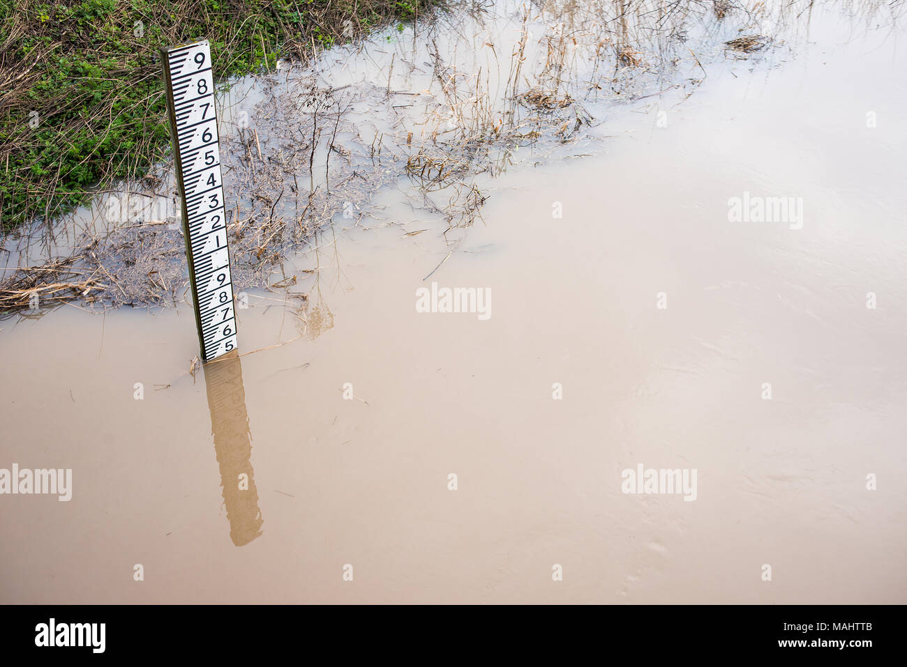 High water levels from a river causing flooding, brought on by climate ...