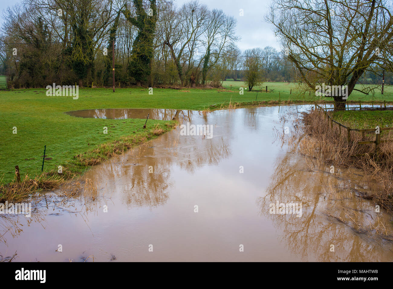 High water levels from a river causing flooding, brought on by climate ...