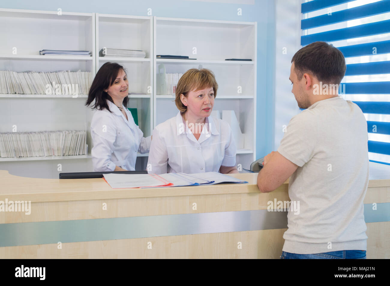 Asian male reception desk hi-res stock photography and images - Alamy