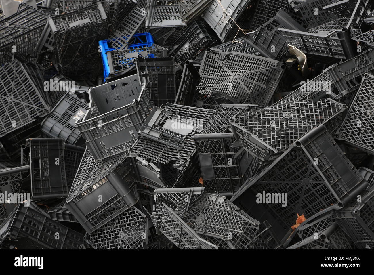 Piled black crates for scrap Stock Photo - Alamy