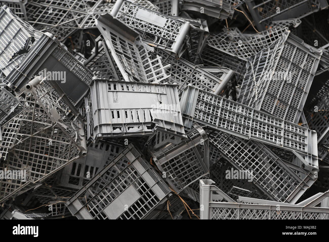 Piled black crates for scrap Stock Photo - Alamy