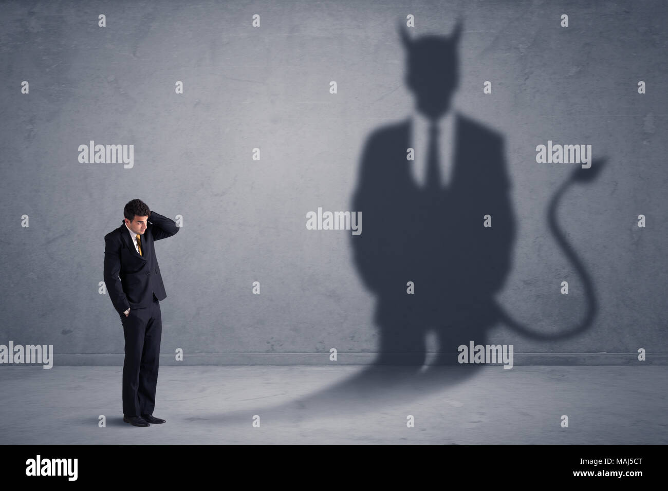 Business man looking at his own devil demon shadow concept background ...