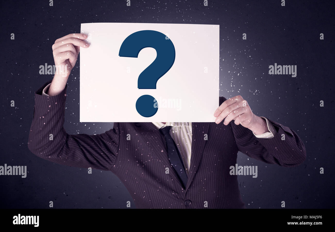 Young businessman hiding behind a question mark drawn on paper Stock ...