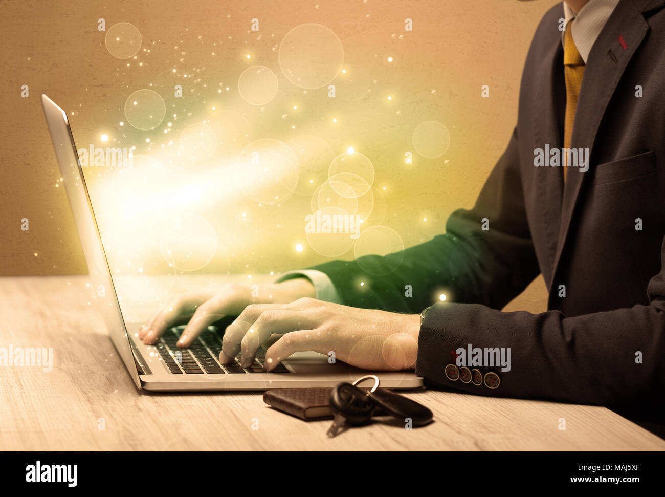 An elegant businessman sitting at desk and pushing the buttons of his ...