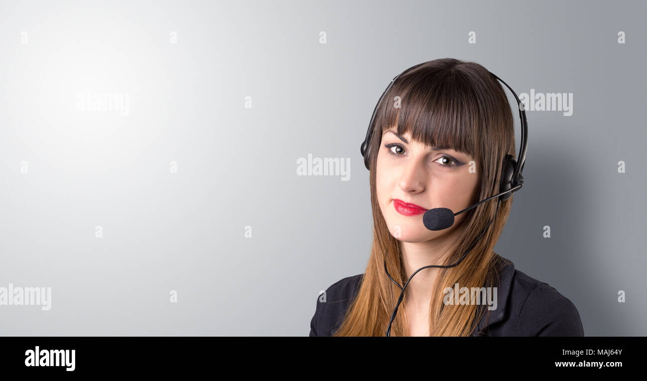 Young female telemarketer on a white background Stock Photo - Alamy