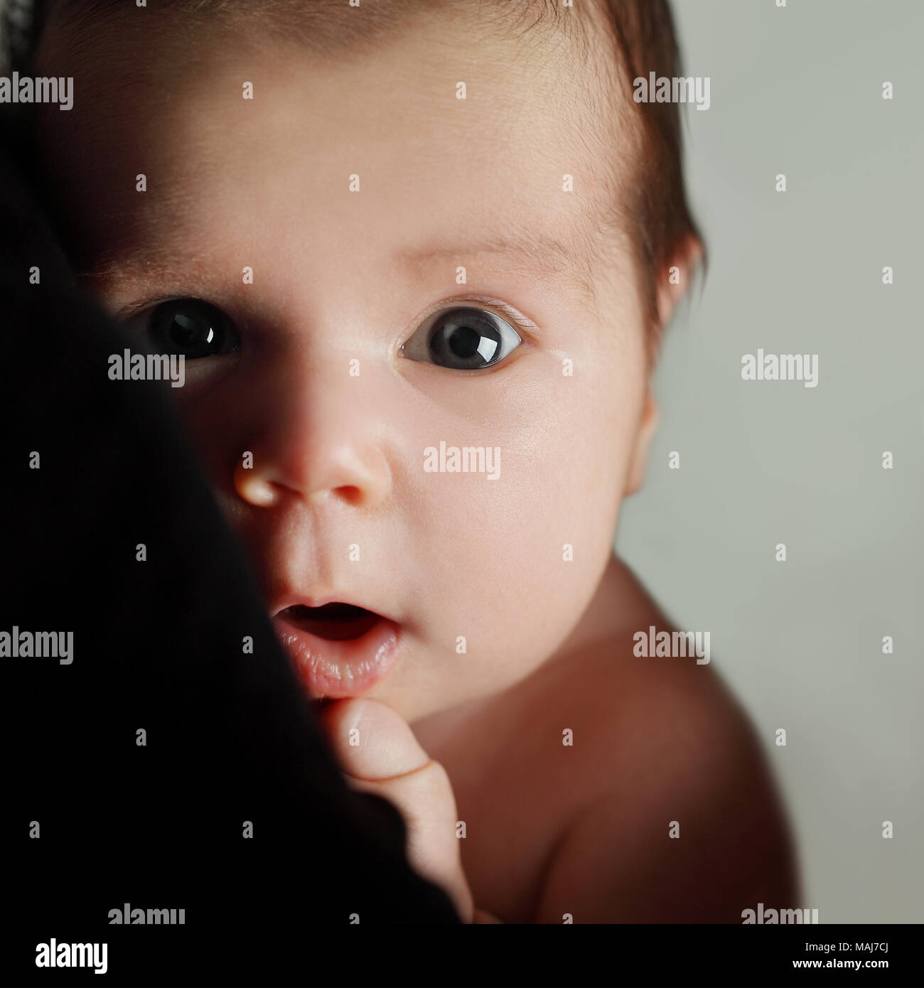 Cute baby, dark light portrait Stock Photo - Alamy