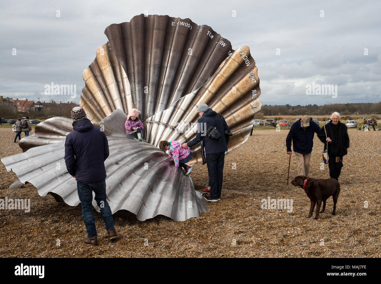 People admiring 'The Scallop', 2003, a sculpture on Aldeburgh beach ...