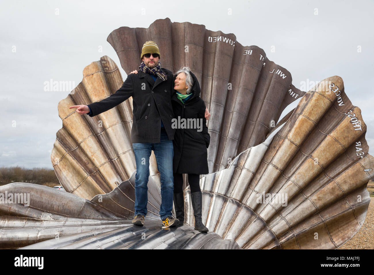 People admiring 'The Scallop', 2003, a sculpture on Aldeburgh beach ...