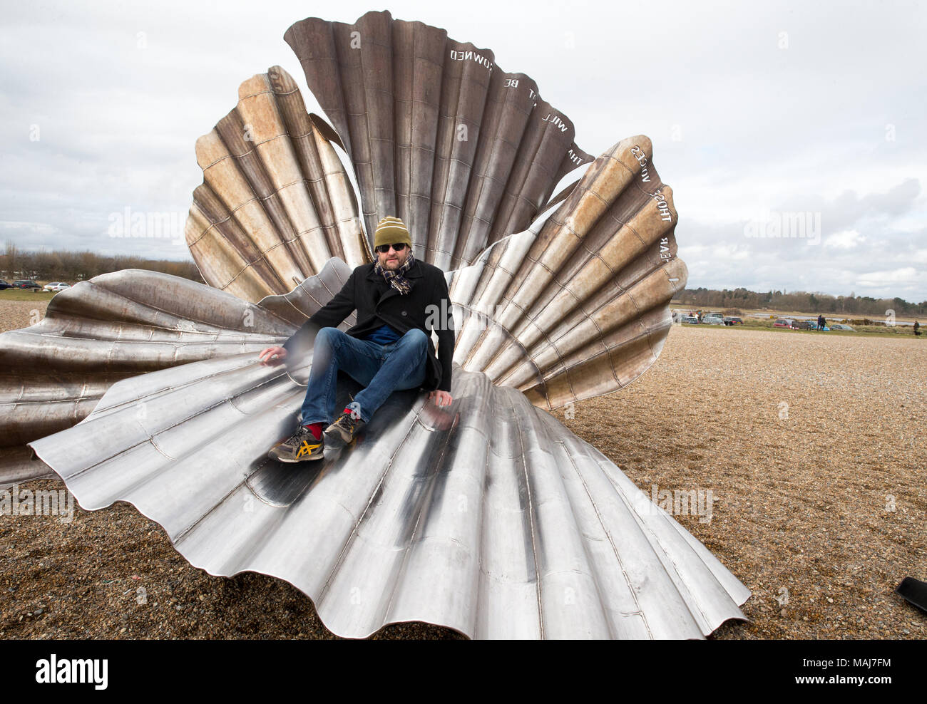 People admiring 'The Scallop', 2003, a sculpture on Aldeburgh beach ...