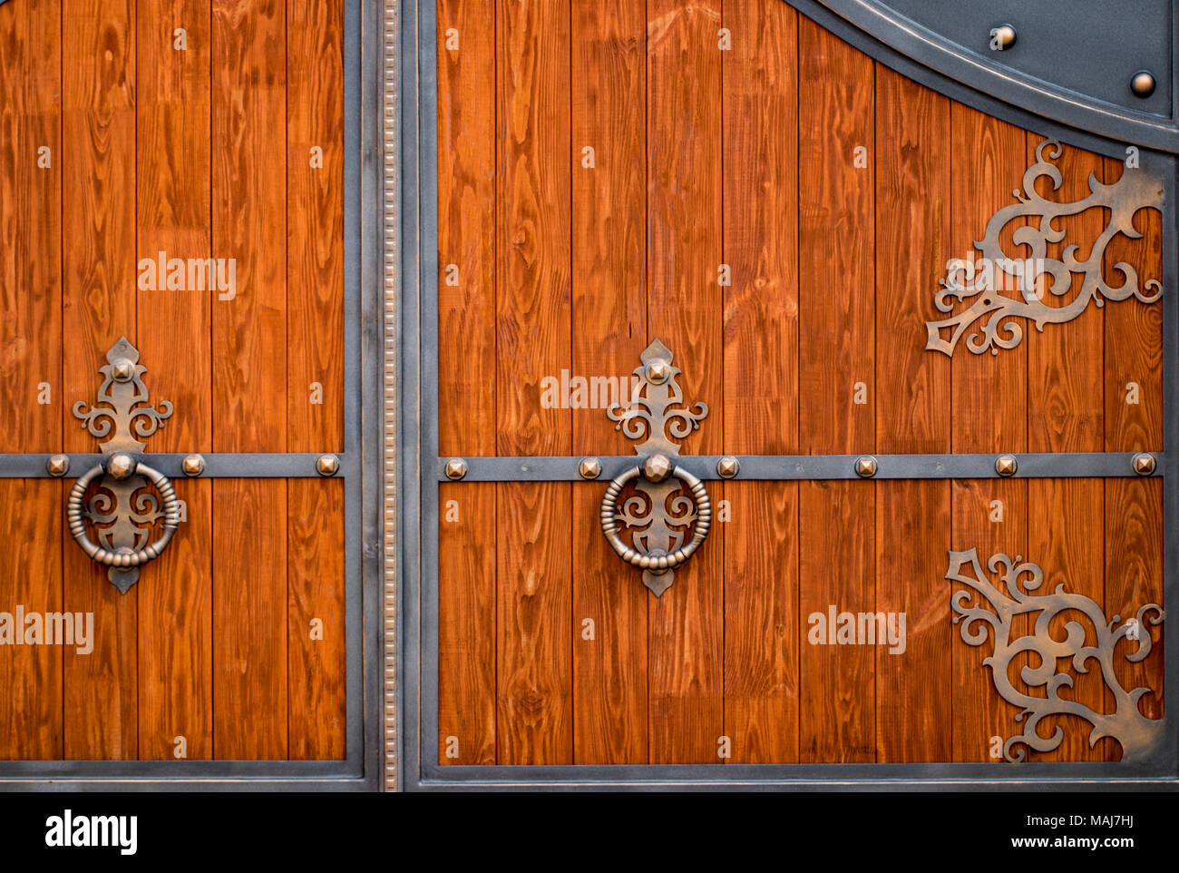 wooden gate with wrought iron elements close up Stock Photo - Alamy