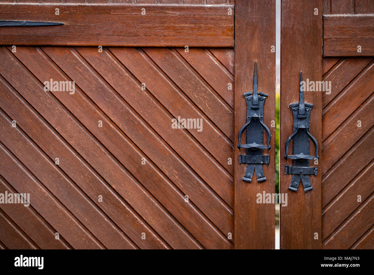 wooden gate with wrought iron elements close up Stock Photo - Alamy