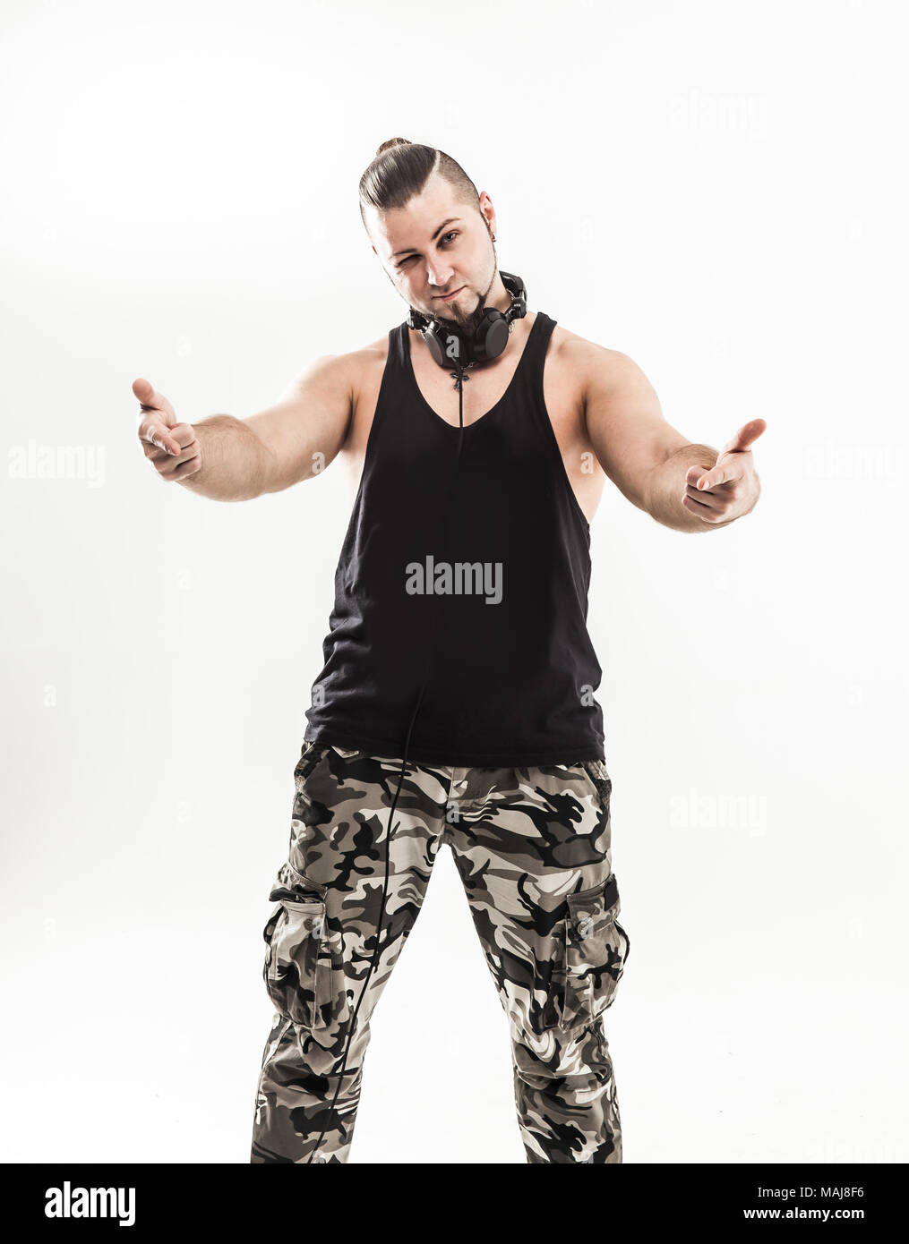 emotional and charismatic DJ - rapper with headphones on a white Stock ...