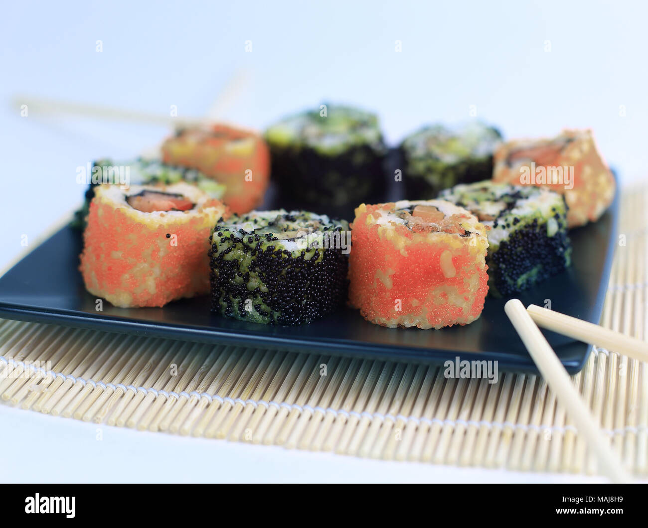 Sushi Set - different types of Maki sushi and chopsticks on a b Stock ...