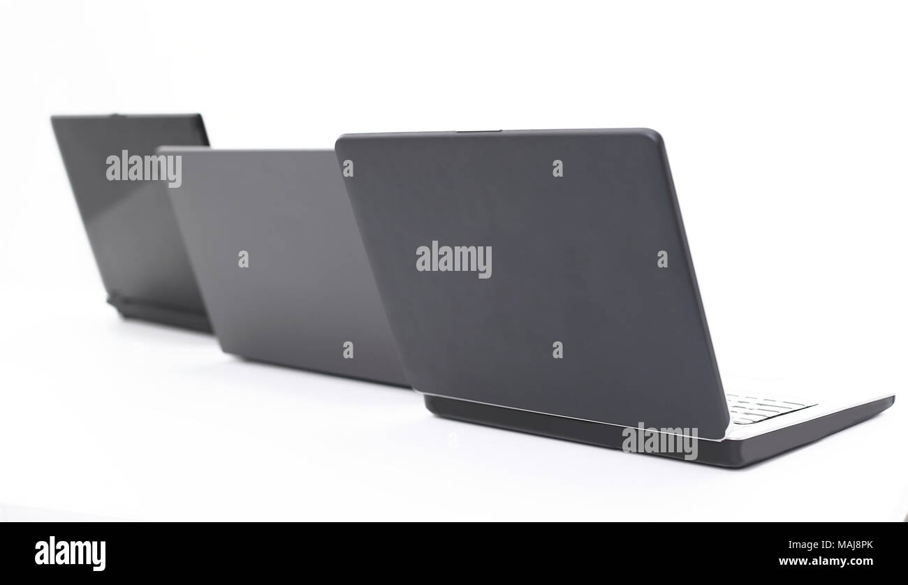 three open laptop in the workplace .isolated on white Stock Photo - Alamy