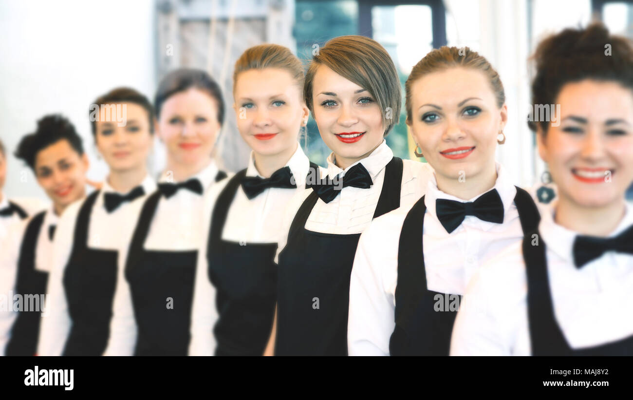 group of waiters at a prestigious restaurant standing in the col Stock ...