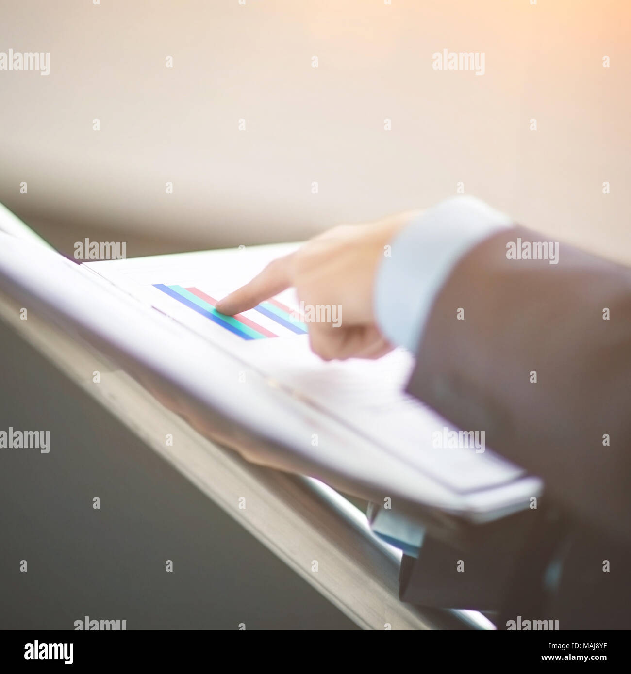 Folder with charts and graphs businessman points his finger to the ...