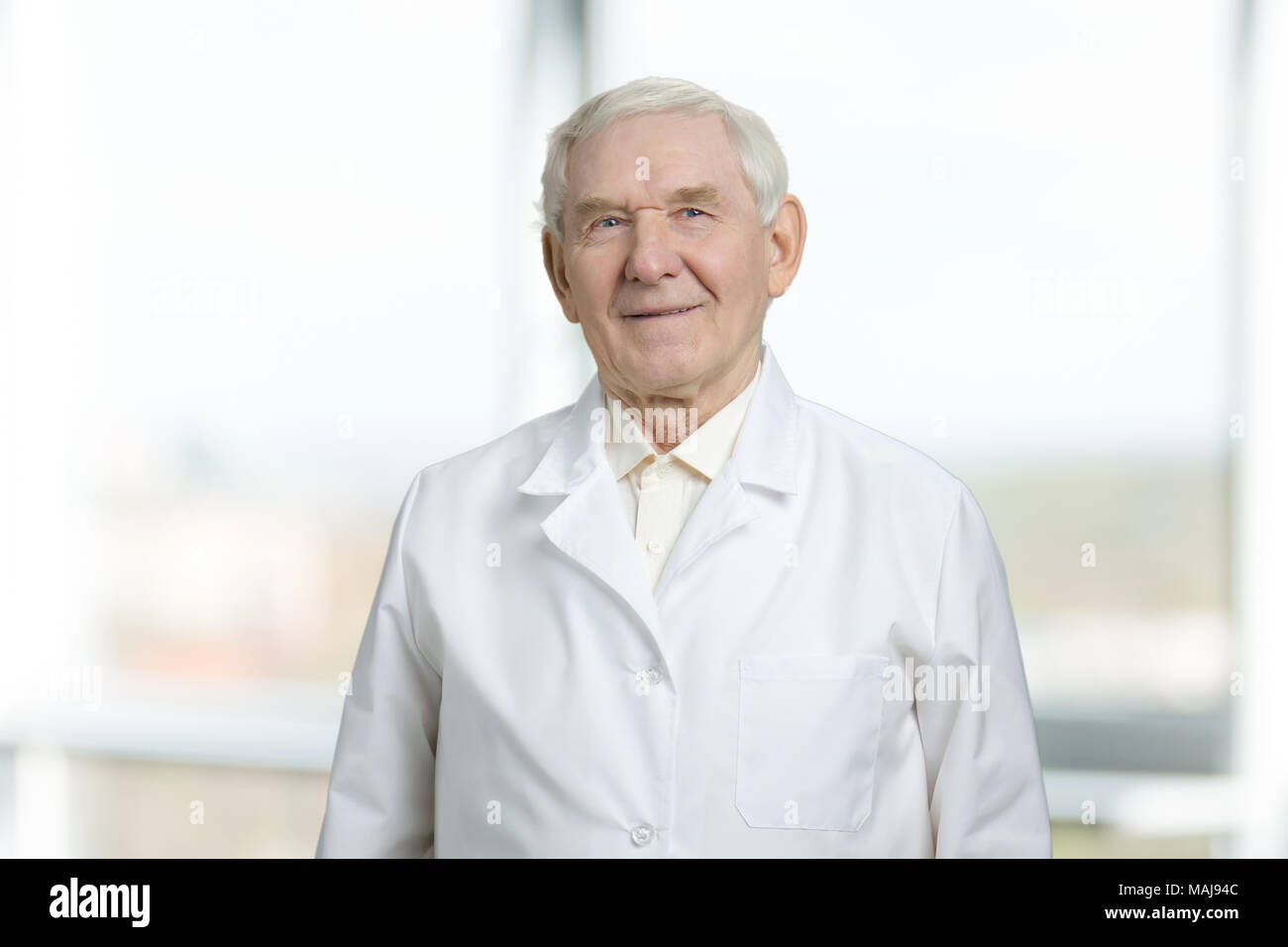 Very old man in white uniform. Gaze of senior physician, portrait of ...