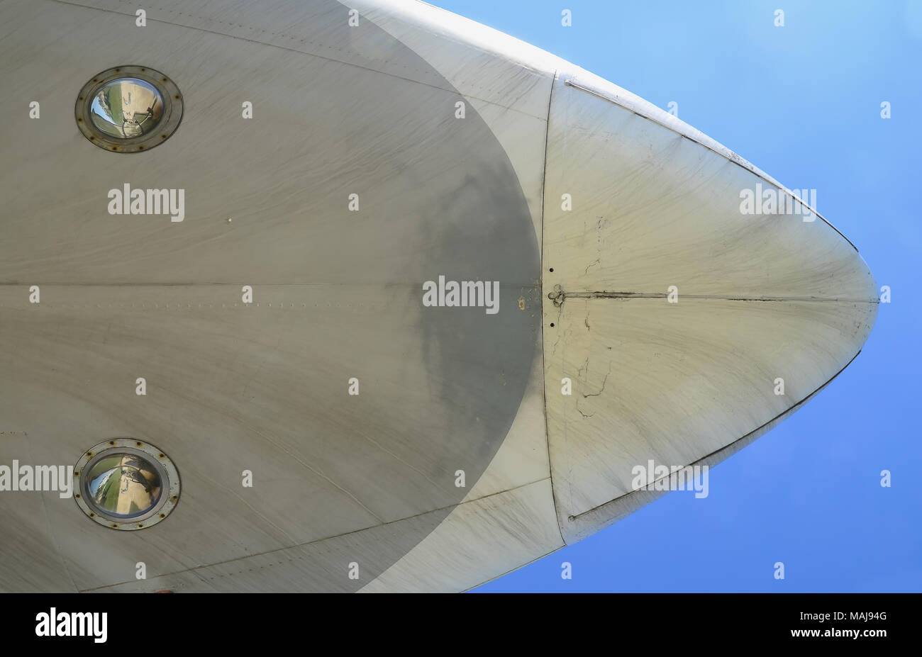 Nose of a white large plane. Bottom view Stock Photo - Alamy